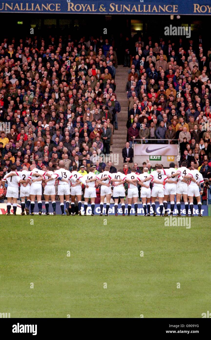 The England team stand arm in arm before the match in front of the ...