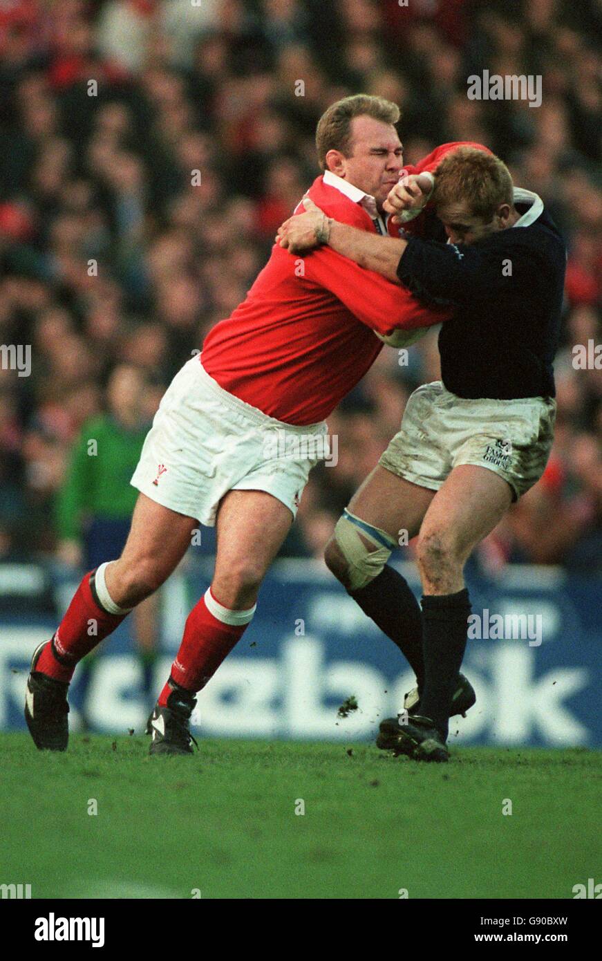 Wales' Scott Quinnell (L) hands off Scotland's Adam Roxburgh (R Stock ...