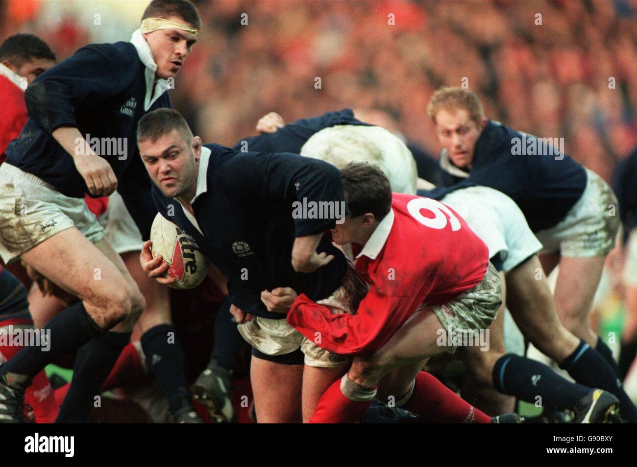 Scotland's Eric Peters is tackled by Wales' Rob Howley Stock Photo - Alamy