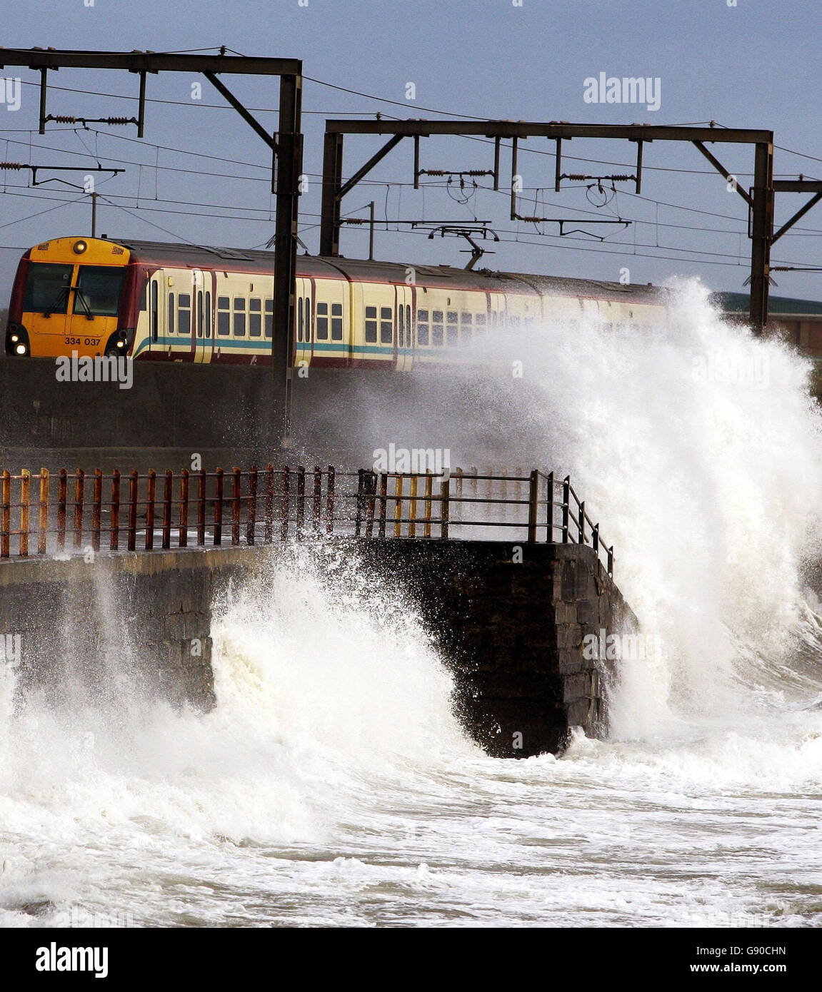 A train goes past the seafront in the coastal town of Saltcoat on the ...