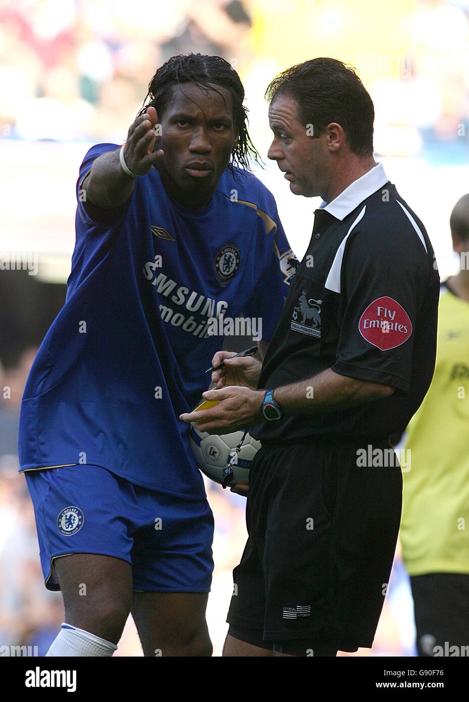 Chelsea's Didier Drogba is booked by referee Rob Styles for discent ...