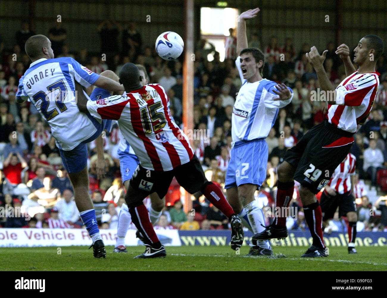 Swindon Town's Andrew Gurney (L) challenges Brentford's Isaiah Rankin ...
