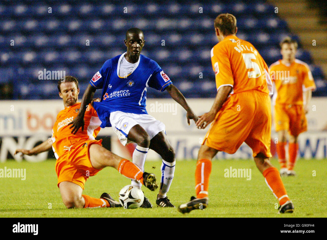 Leicester City's Momo Sylla and Blackpool's Simon Grayson battle for ...