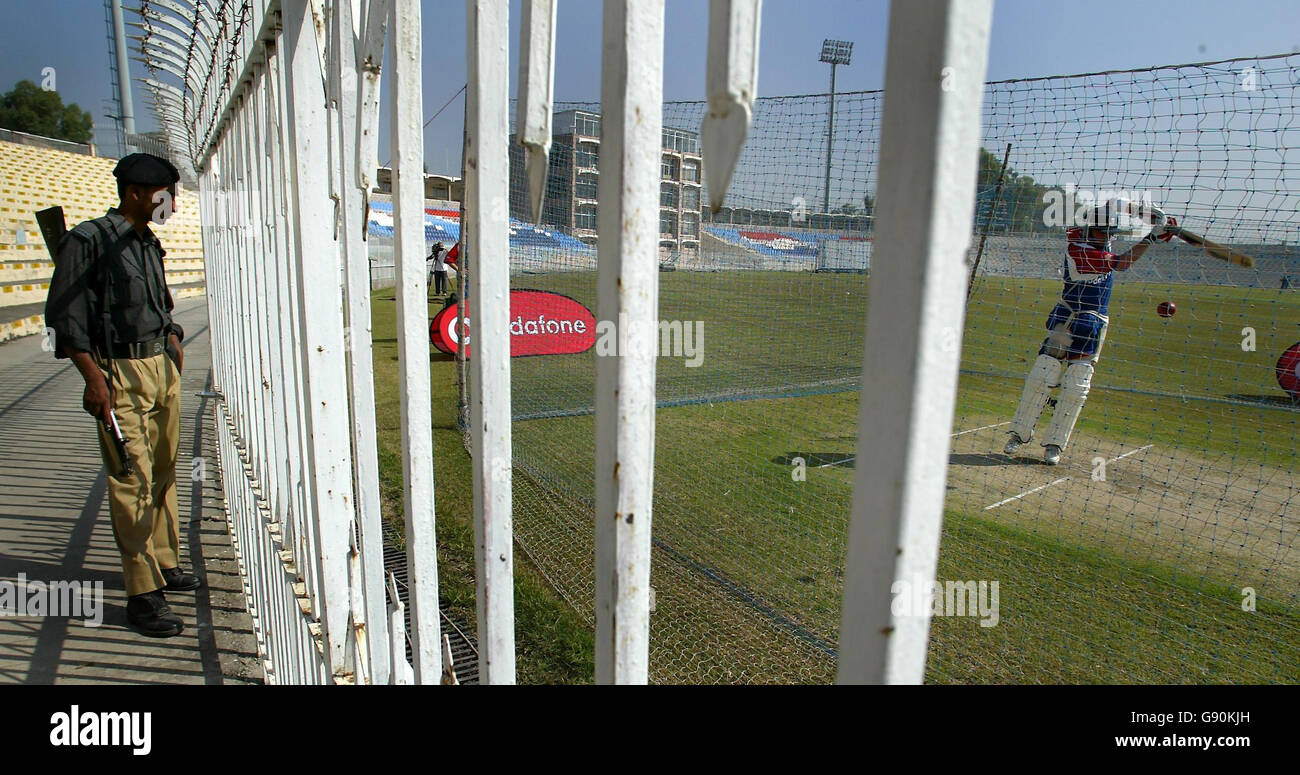 An armed pakistan policeman keeps a watch over England batsman Ian Bell ...