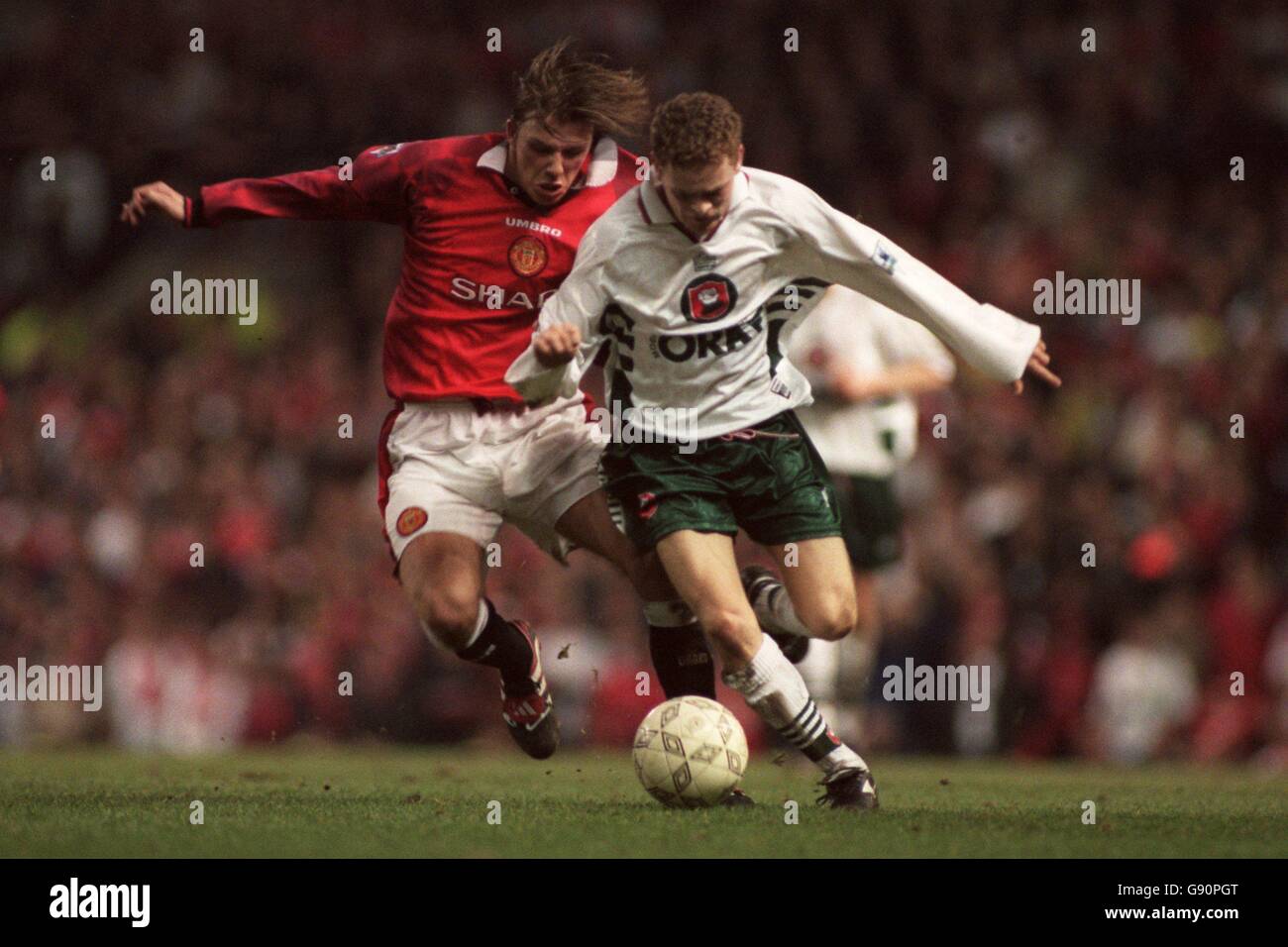 Manchester United's David Beckham clashes with Barnsley's Martin ...