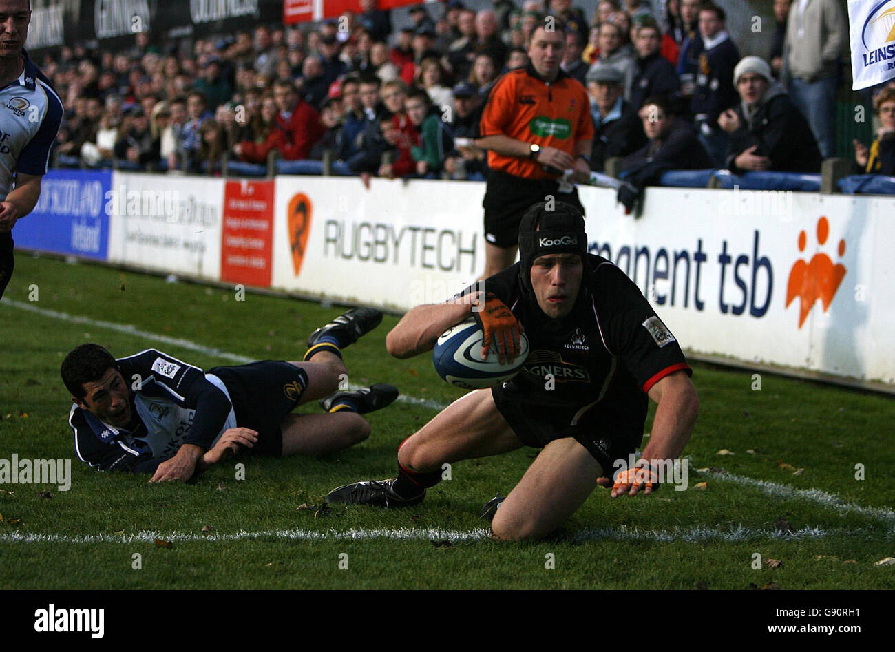 Edinburgh's Simon Webster scores a try past Leinster's Robert Kearney ...