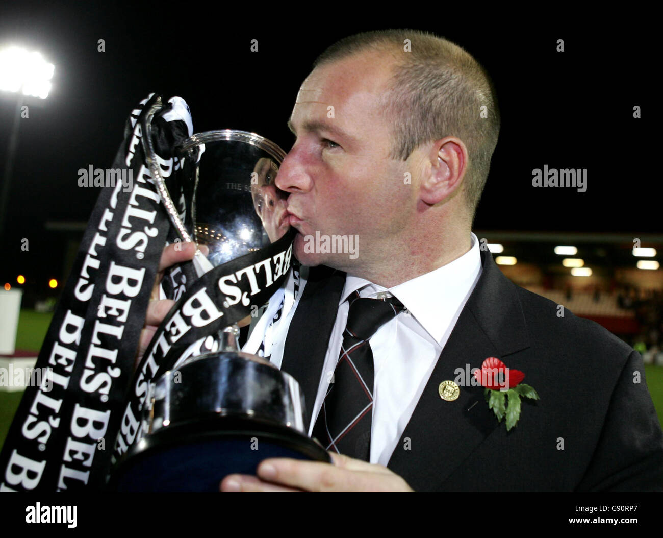 St Mirren boss Gus MacPherson celebrates with the trophy after winning ...