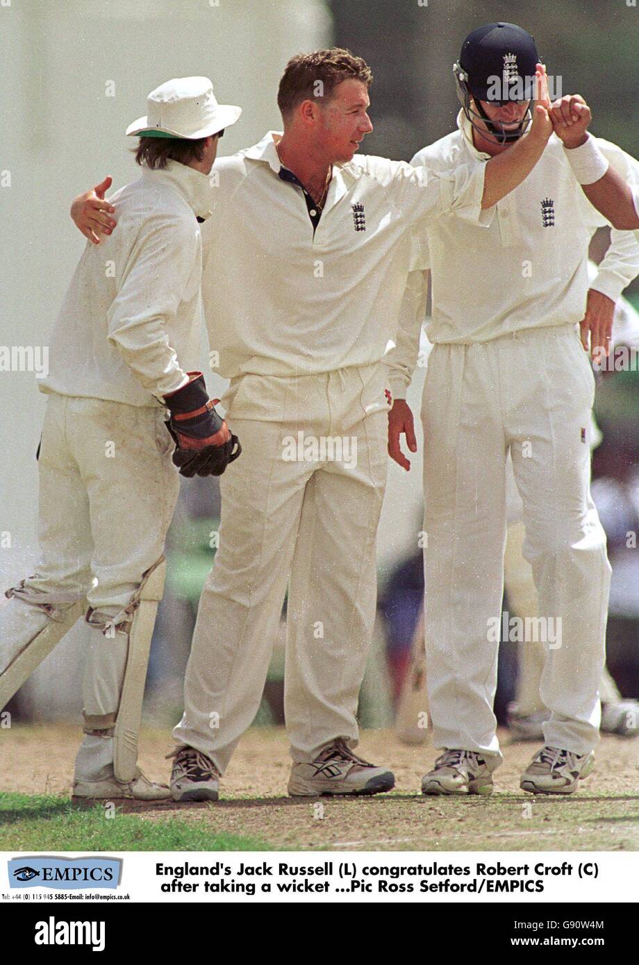 England's Jack Russell (left) congratulates Robert Croft (centre) on ...