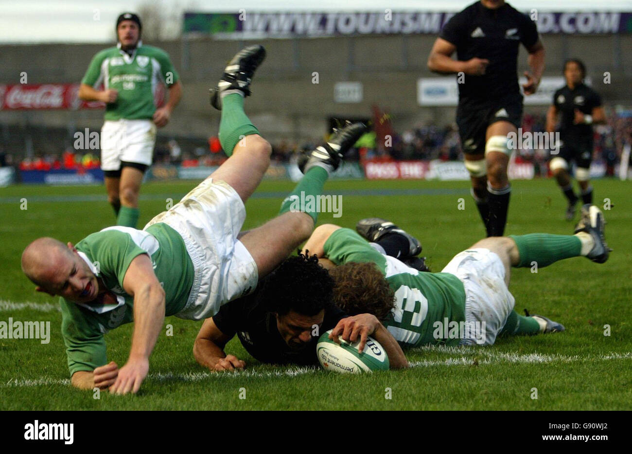 New Zealand's Doug Howlett beats the tackles of Ireland's Gordon D'Arcy ...