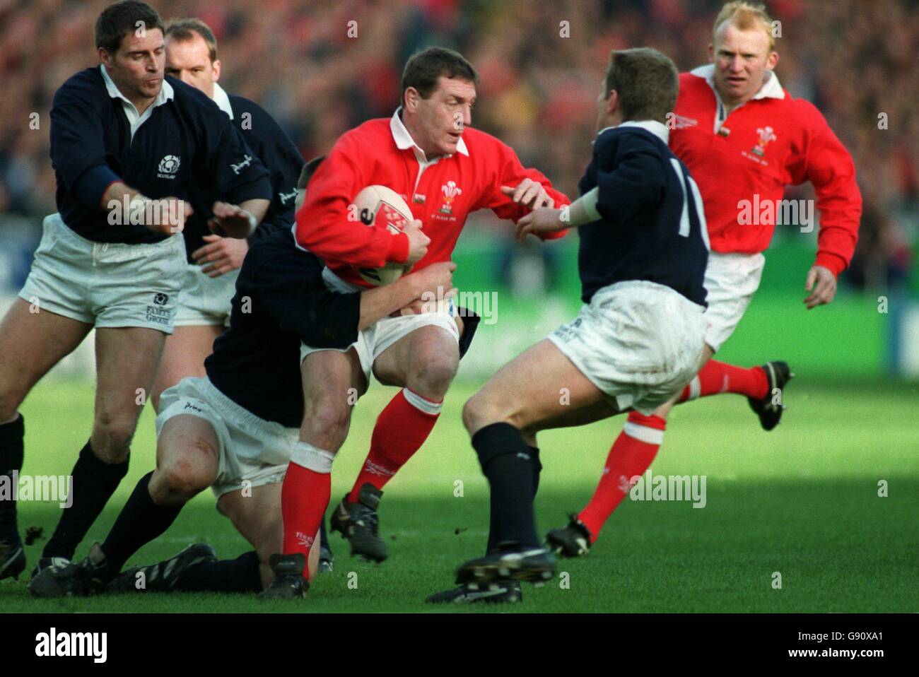Scotland's Alan Tait (L), Craig Chalmers (R) and Wales' Allan Bateman ...