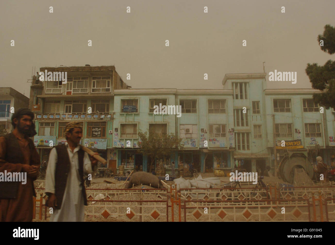 A street scene shot out of a window of a moving vehicle in Mazar-e ...
