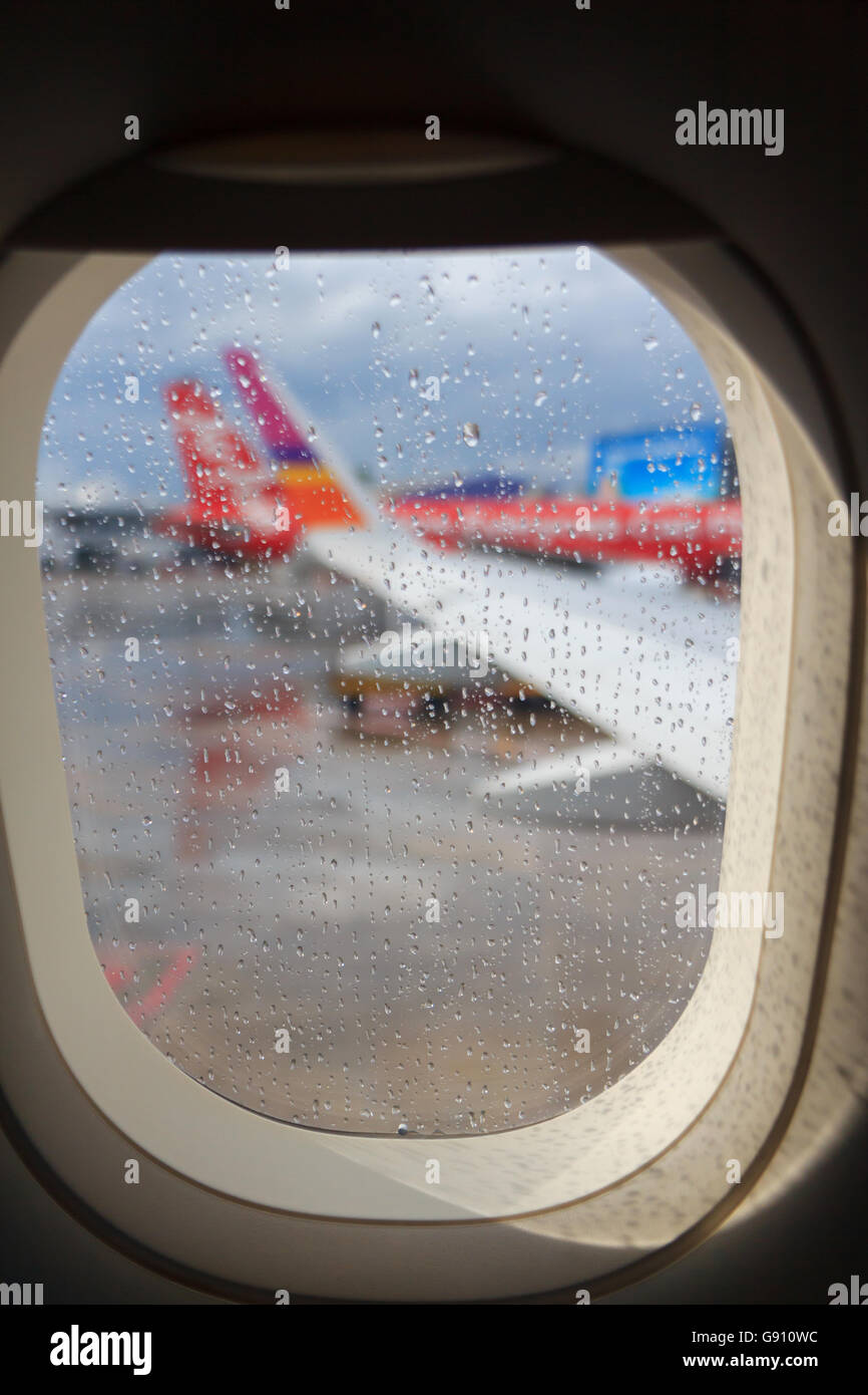 Rain drops view through airplane window Stock Photo - Alamy