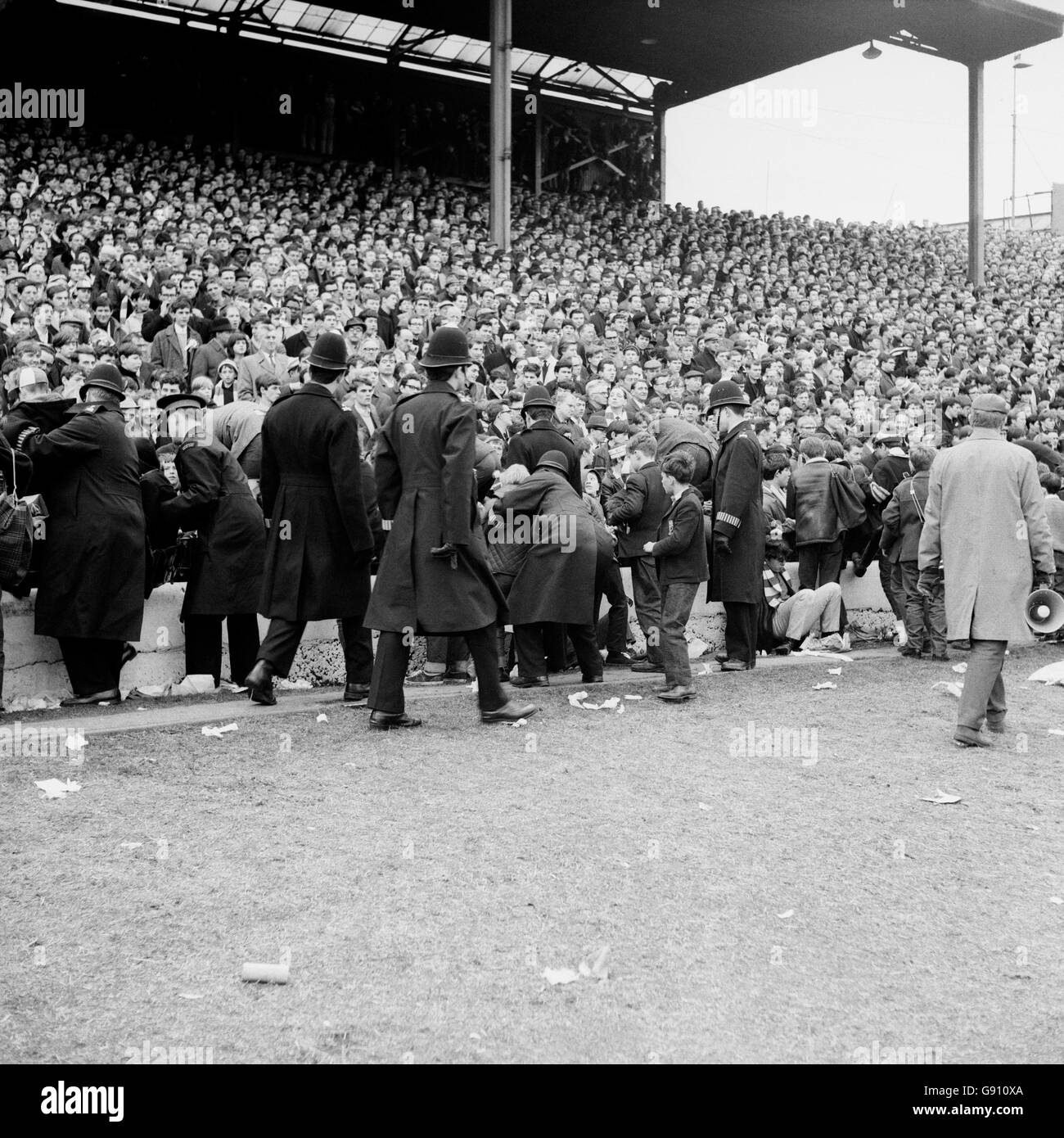 Police try and make fans return to the terraces after they had spilled ...