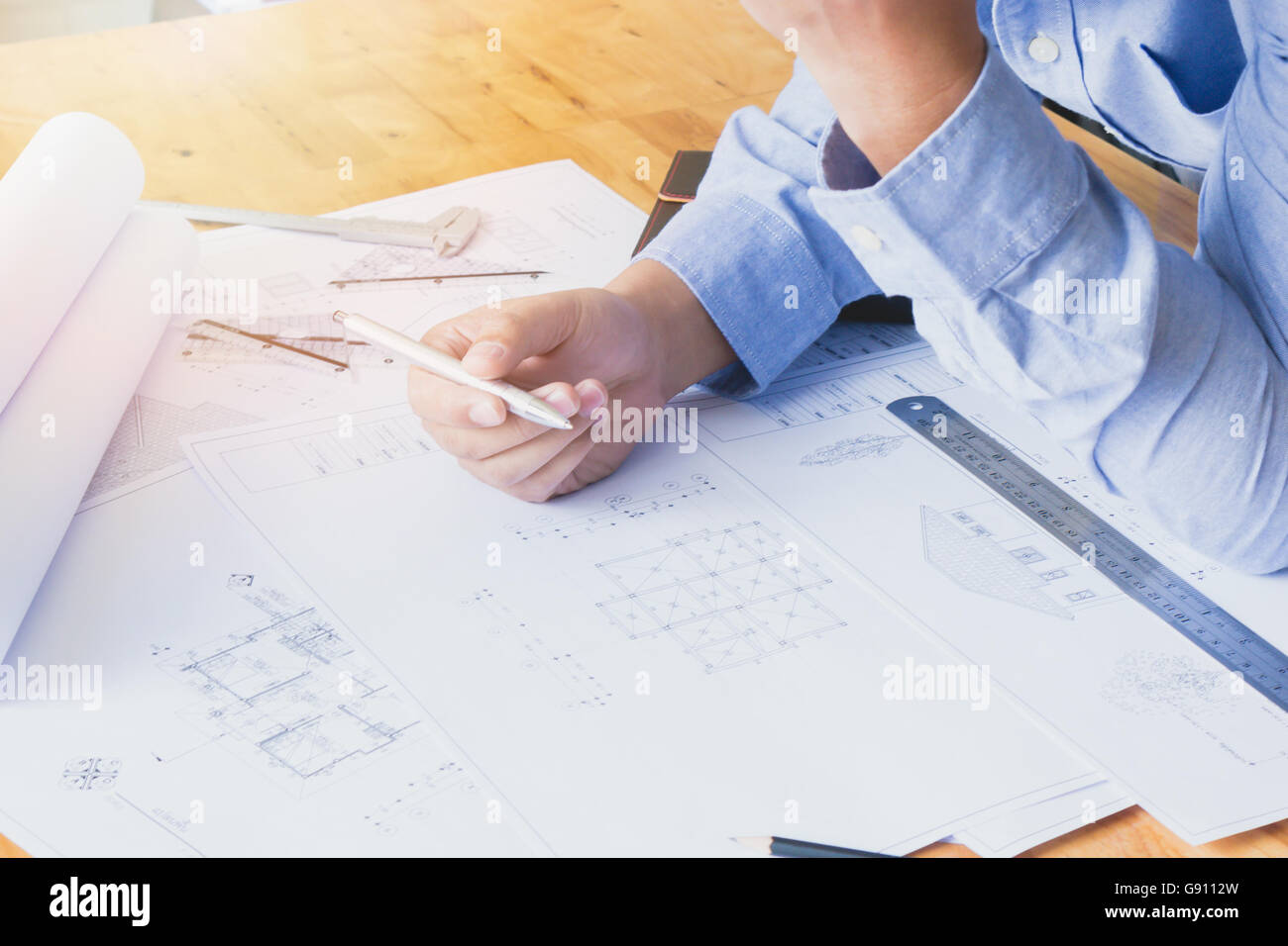 Architects concept, Architects working with blueprints in the office ...