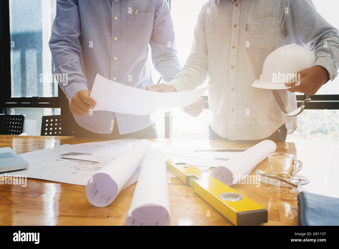 Architects concept, Architects working with blueprints in the office ...