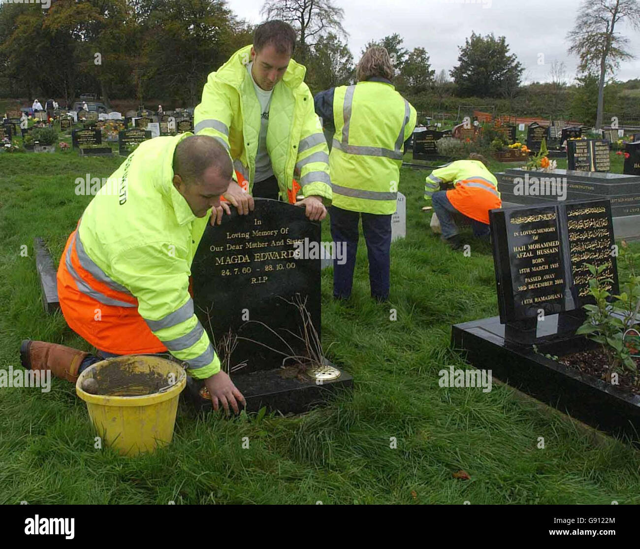 Workman re-erect damaged headstones at Handsworth Cemetery, Birmingham ...