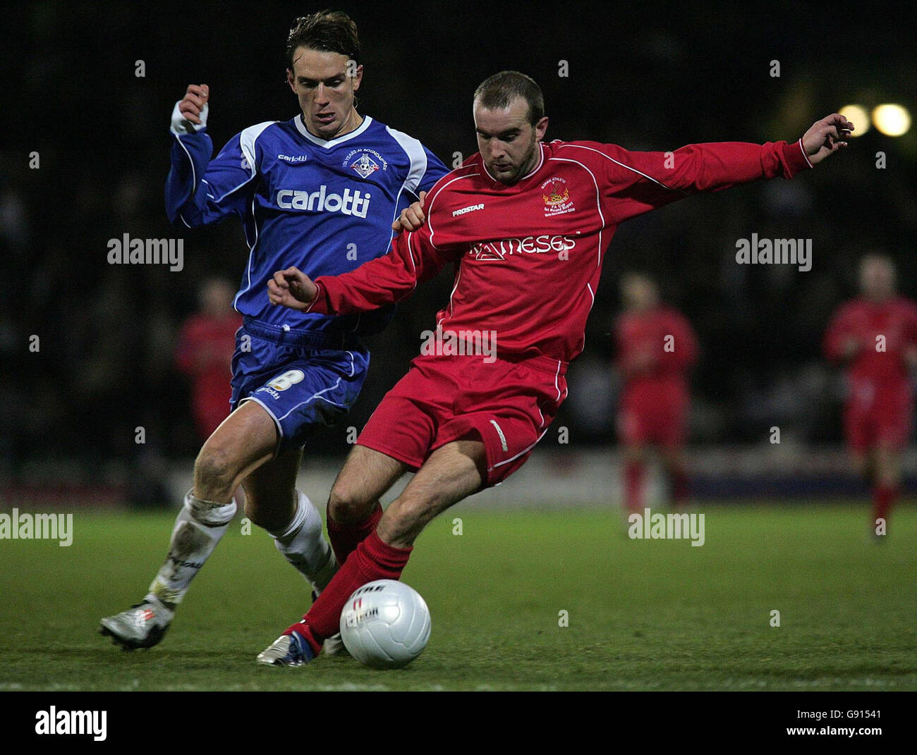 Chasetown's Lee Bullimore (R) holds the ball away from Oldham's Mark ...