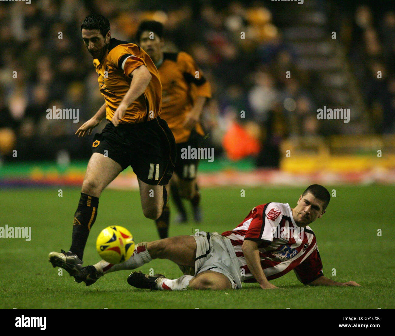 Wolverhampton Wanderers' Mark Kennedy (L) skips over a tackle from ...