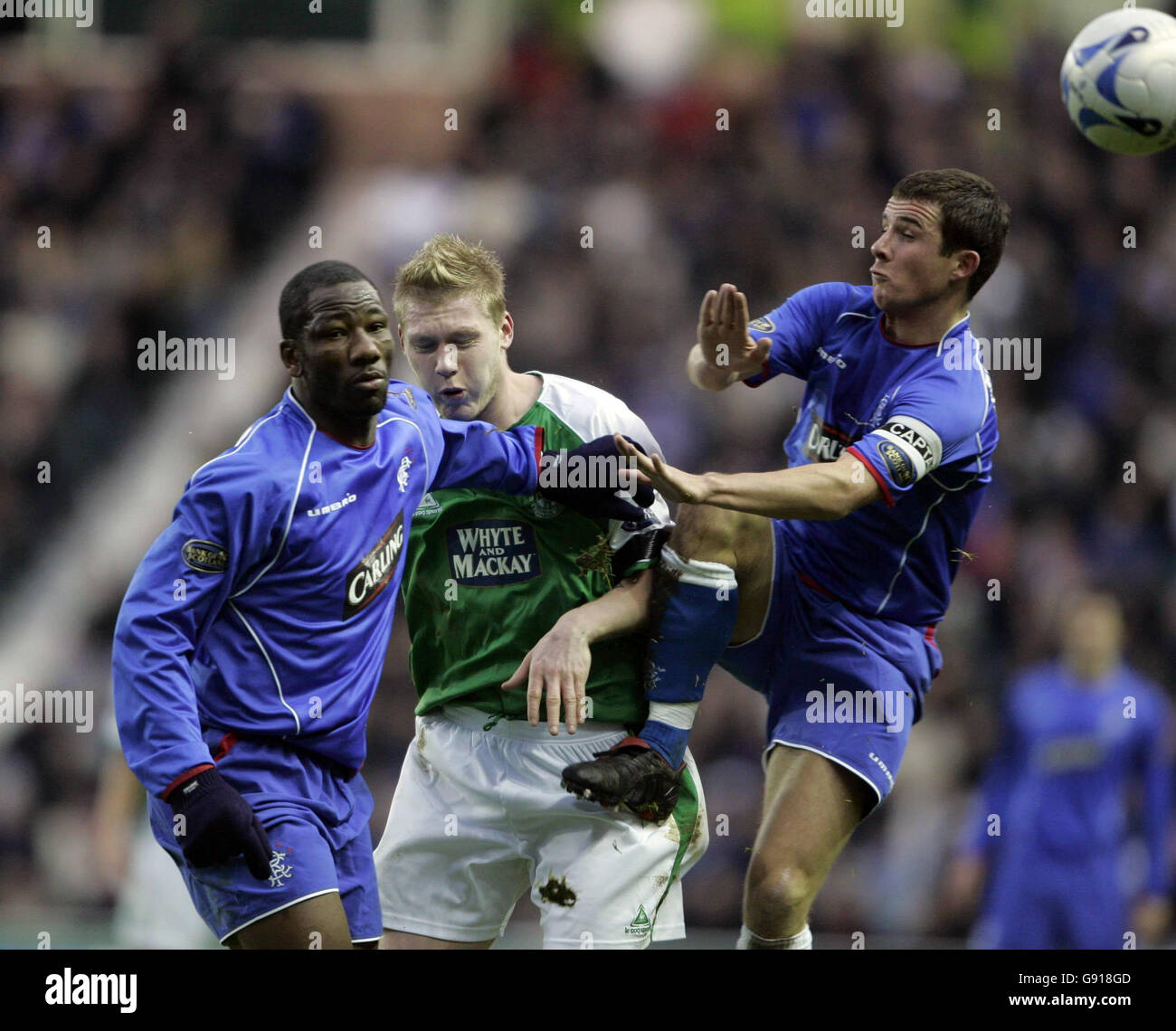 Rangers Marvin Andrews (L) and Bary Ferguson challenge Hibernian's ...