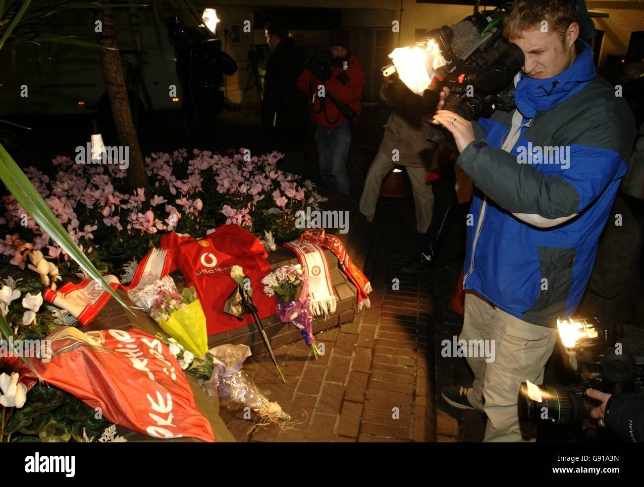 George Best's Manchester United shirt and flowral tributes are left by ...