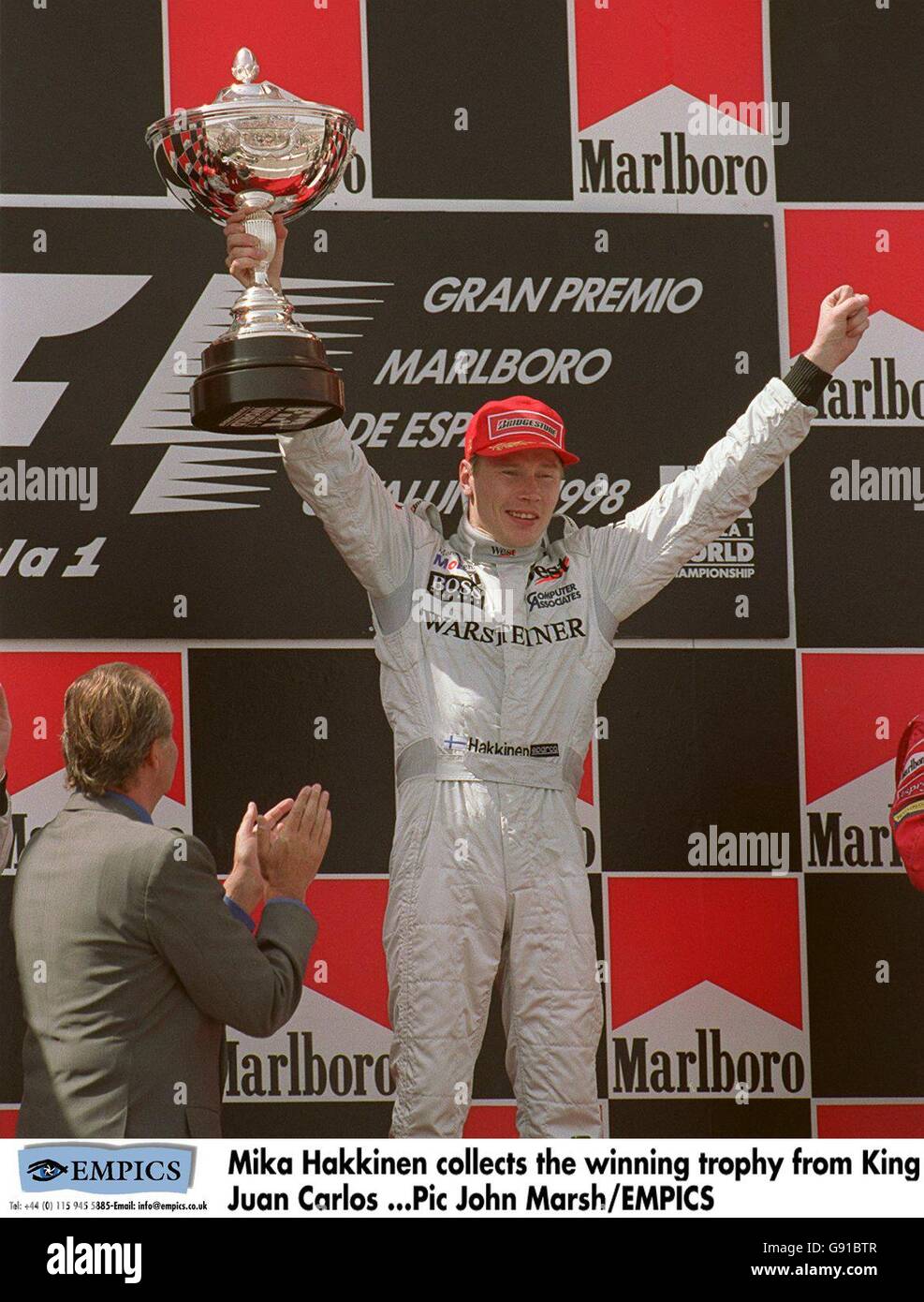 Formula One Motor Racing - Spanish Grand Prix. Mika Hakkinen collects the winning trophy from ...
