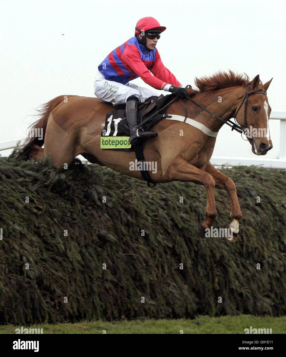 Hakim ridden by jockey Paddy Brennan clears the 'chair' on the way to ...