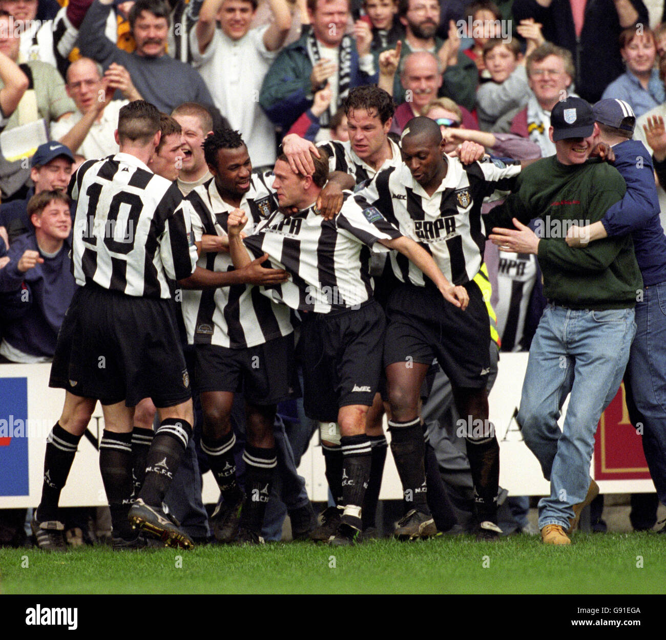 Notts County players and supporters celebrate after Mark Robson (centre ...