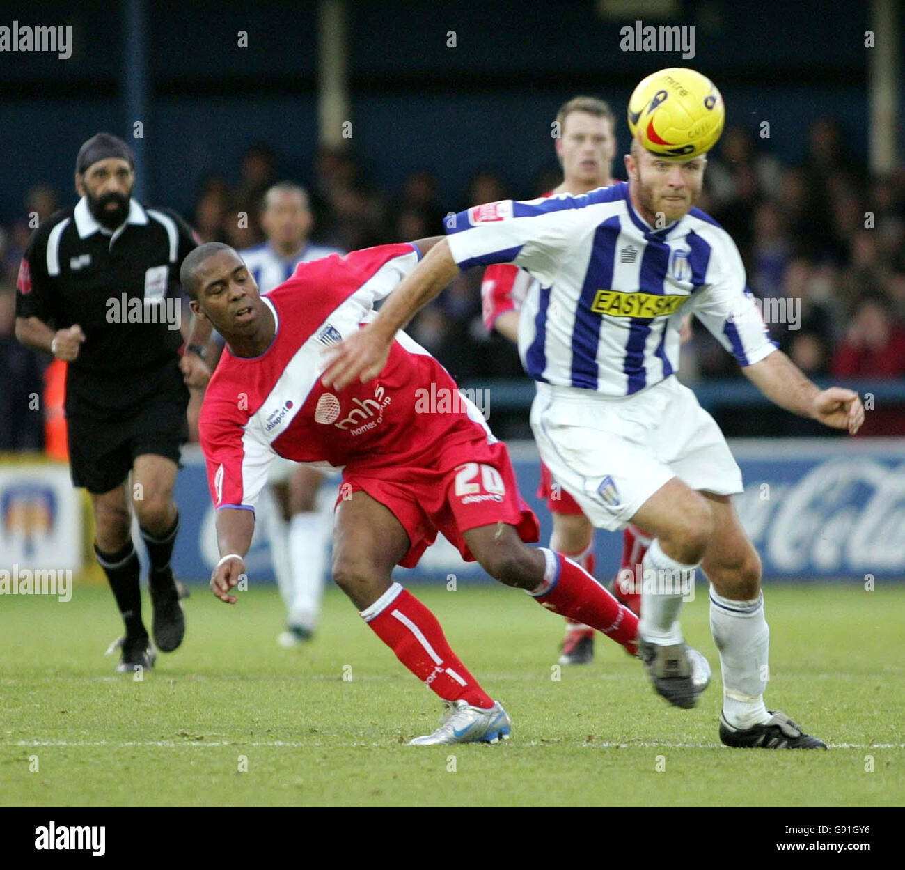 Gillingham's Darren Byfield (L) challenges Colchester's Wayne Brown ...