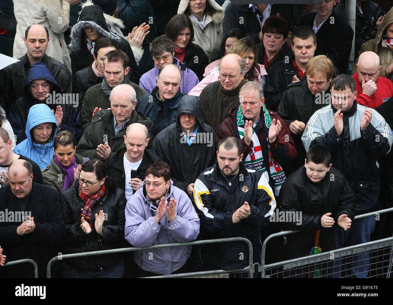 Well-wishers cheer as George Best's funeral cortege passes through the ...