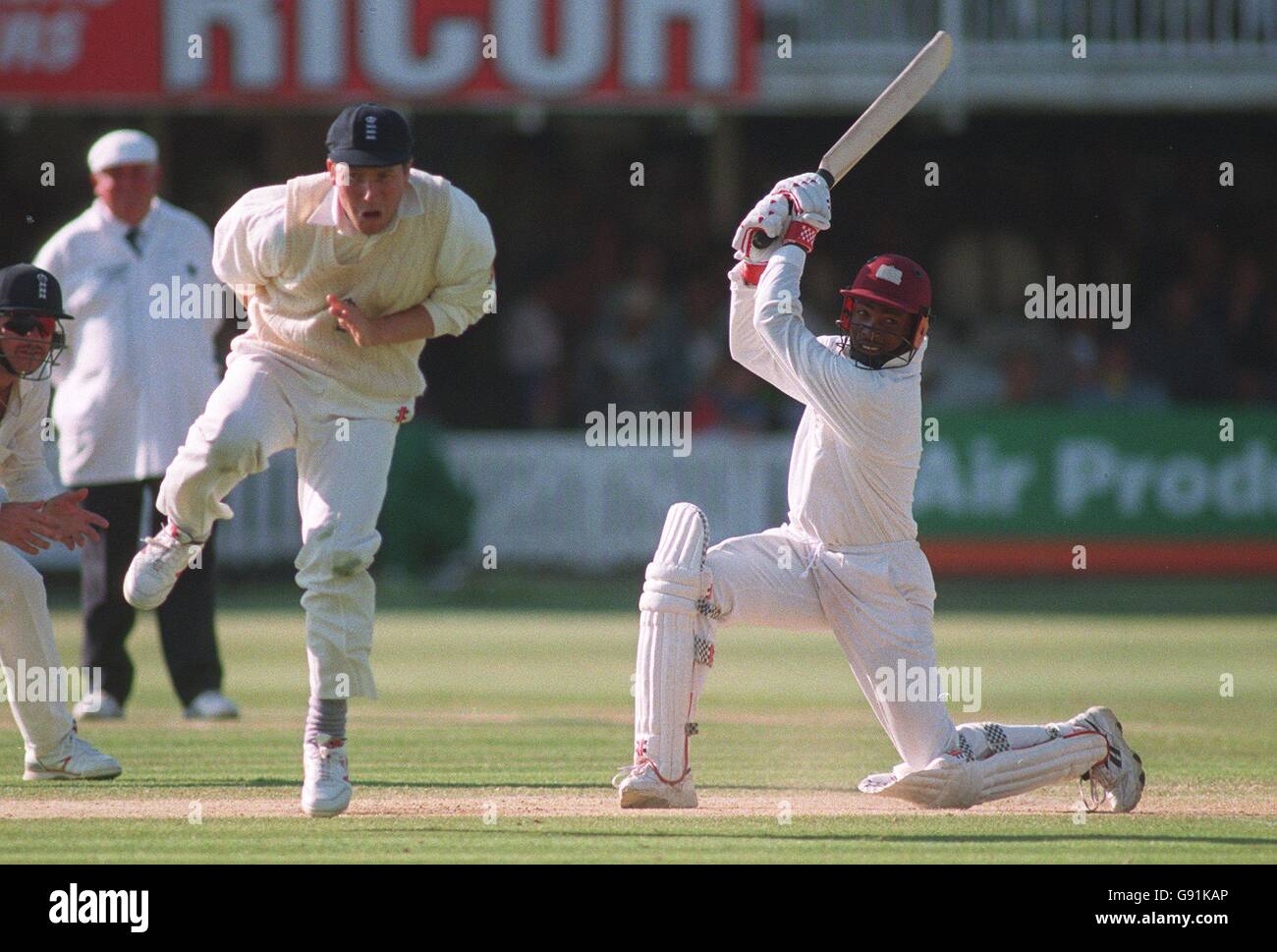 England's Michael Atherton (left) avoids an off drive from West Indies ...