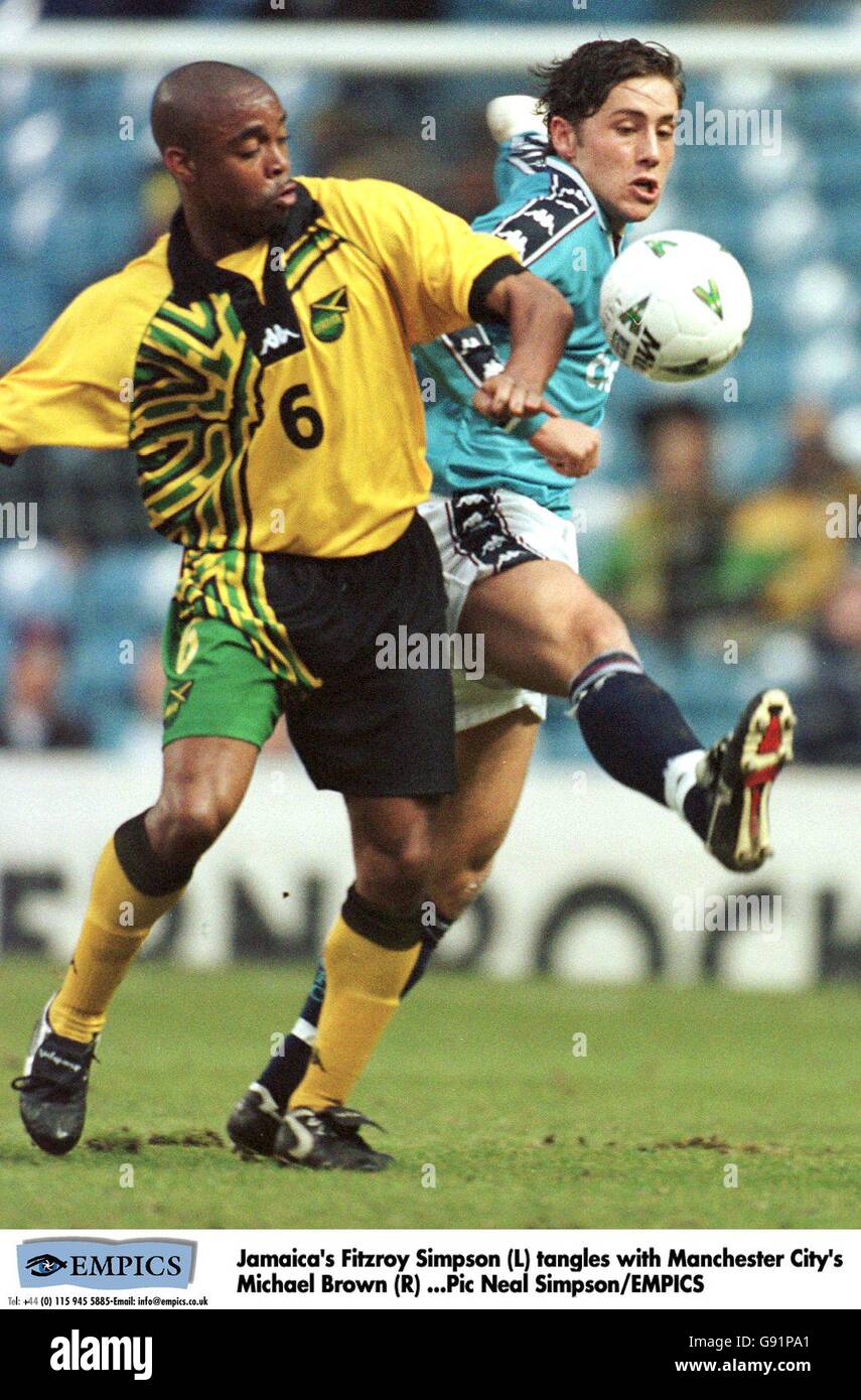 Jamaica's Fitzroy Simpson (L) tangles with Manchester City's Michael ...