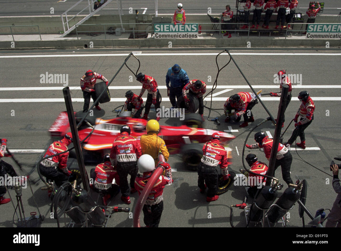 The Williams pit crew get ready to work as Heinz Harald Frentzen enters ...