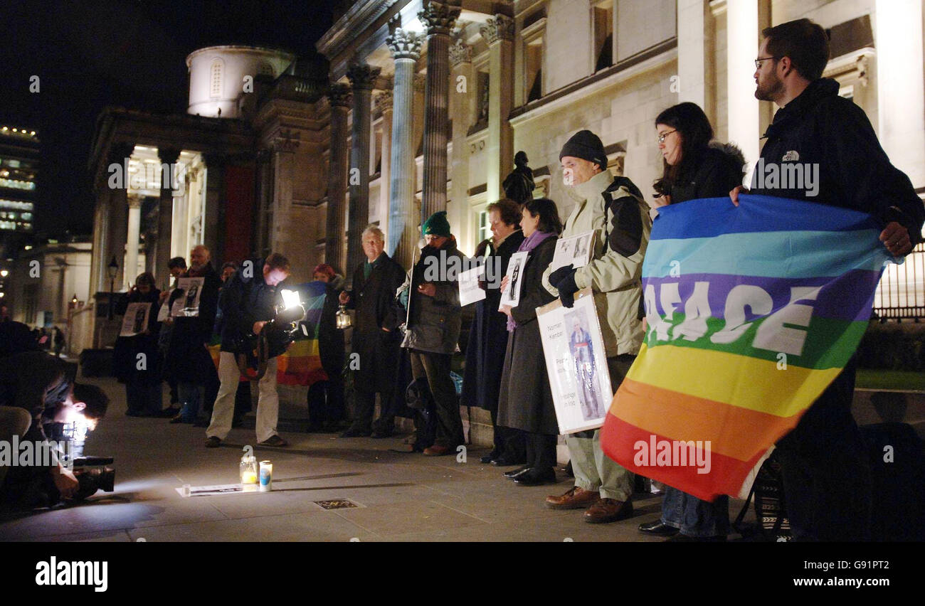 A group stand in silent vigil for Norman Kember in Trafalgar Square ...
