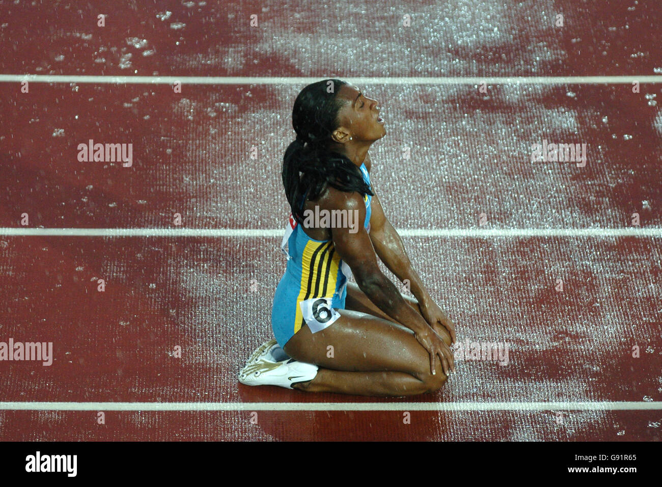Tonique Williams-Darling of the Bahamas celebrates in the rain after ...