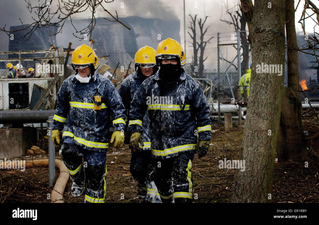 Firefighters take a break after tackling the blaze at the Buncefield ...