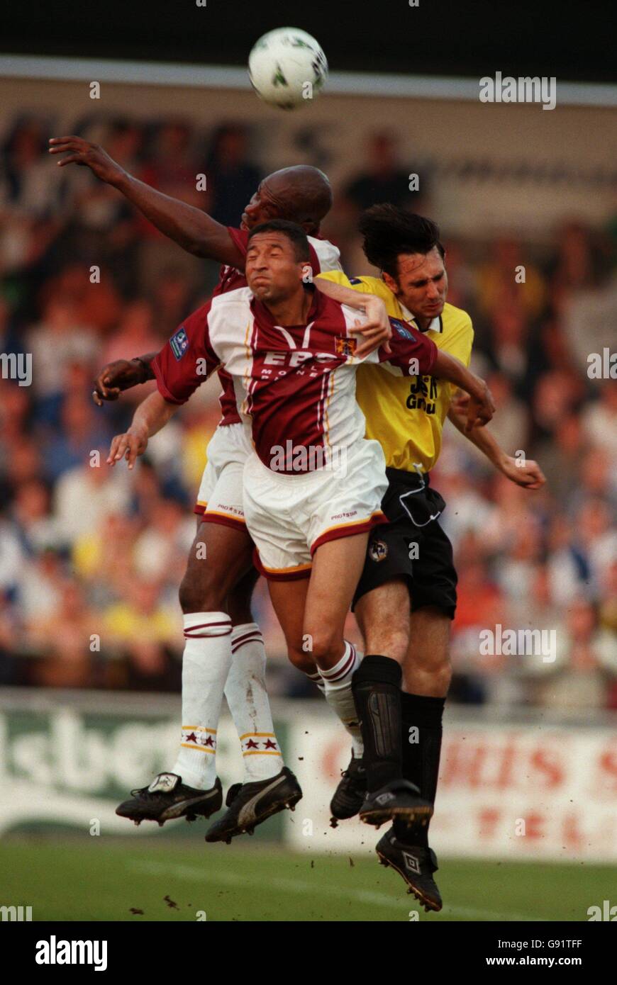 Northampton Town's John Gayle (back) jumps for the ball with his ...