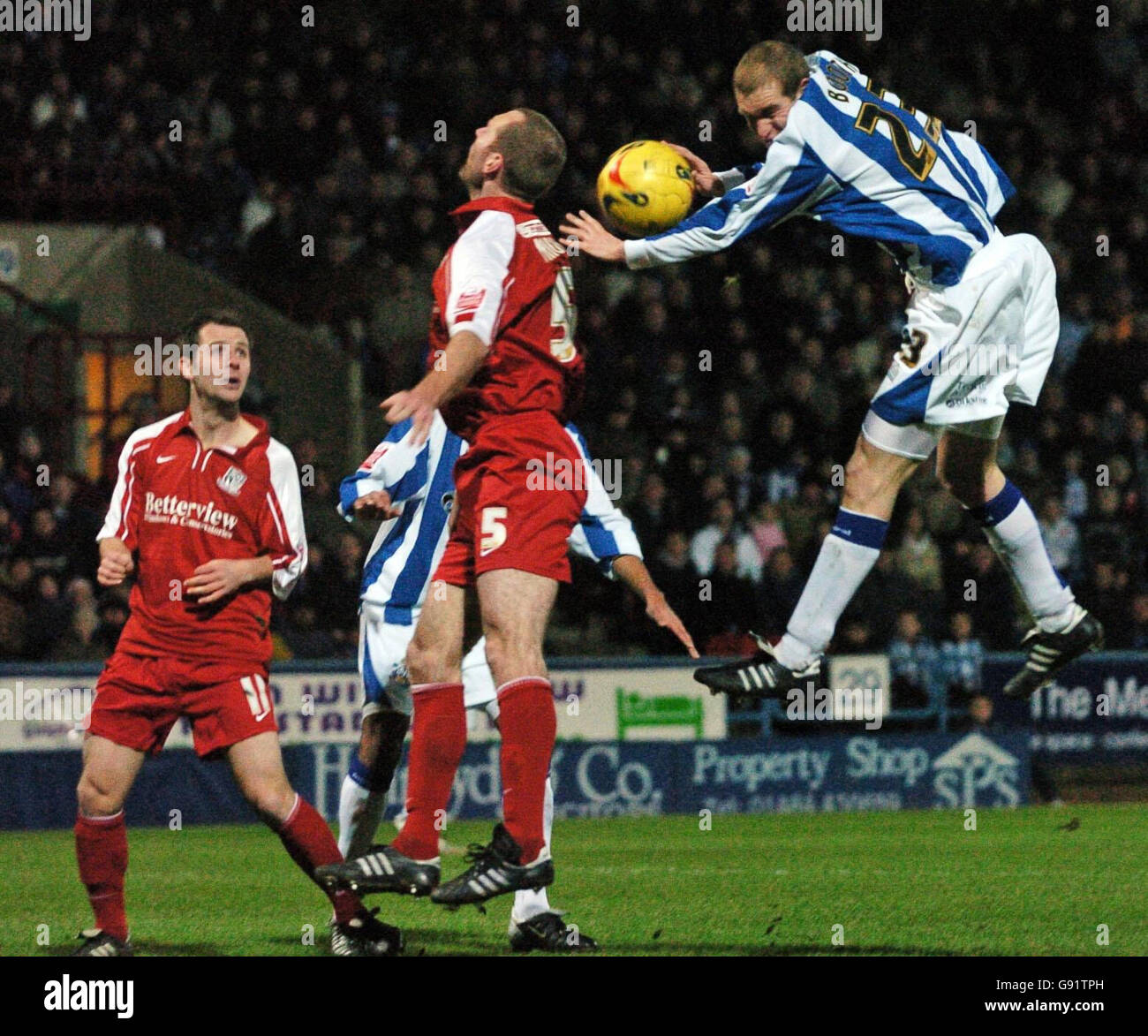 Huddersfield's Andy Booth (R) has his header blocked by Southend's ...