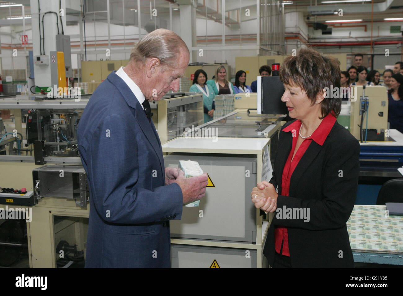 The Duke of Edinburgh picks up and handled a large wad of sealed bank ...