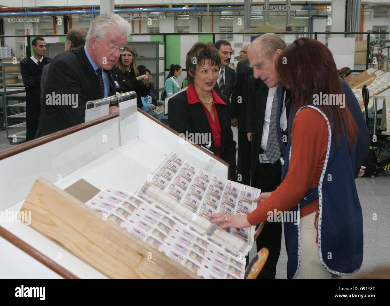 The Duke of Edinburgh is shown sealed bank notes during a visit to a ...