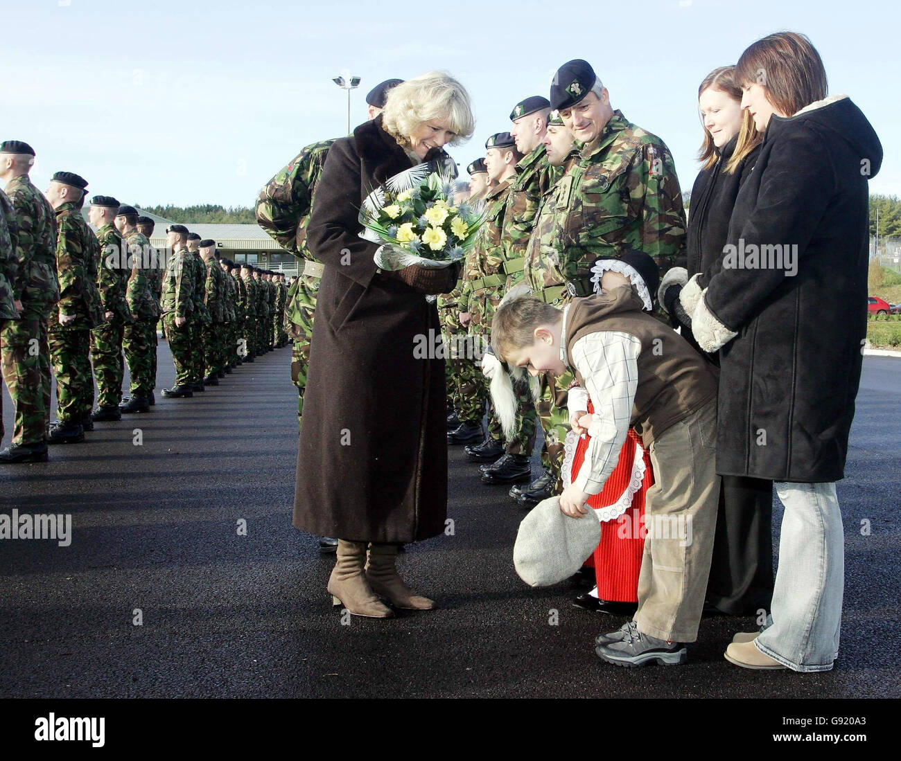 Iestyn Rees, 6, whose father received a medal in the ceremony, bows to ...