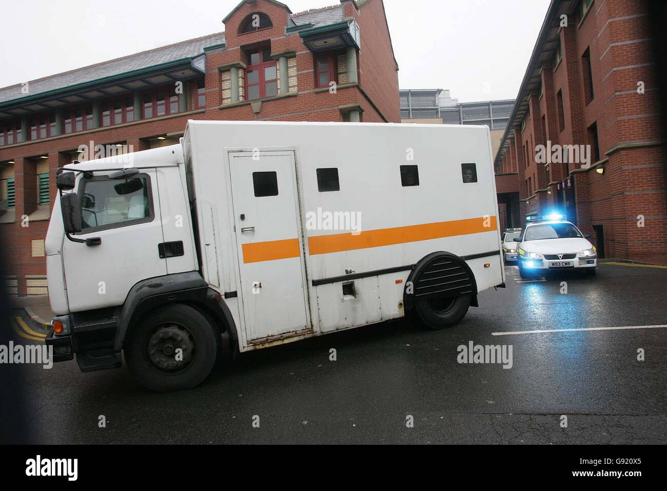 Armed police escort a prison van from Leeds magistrates court November ...