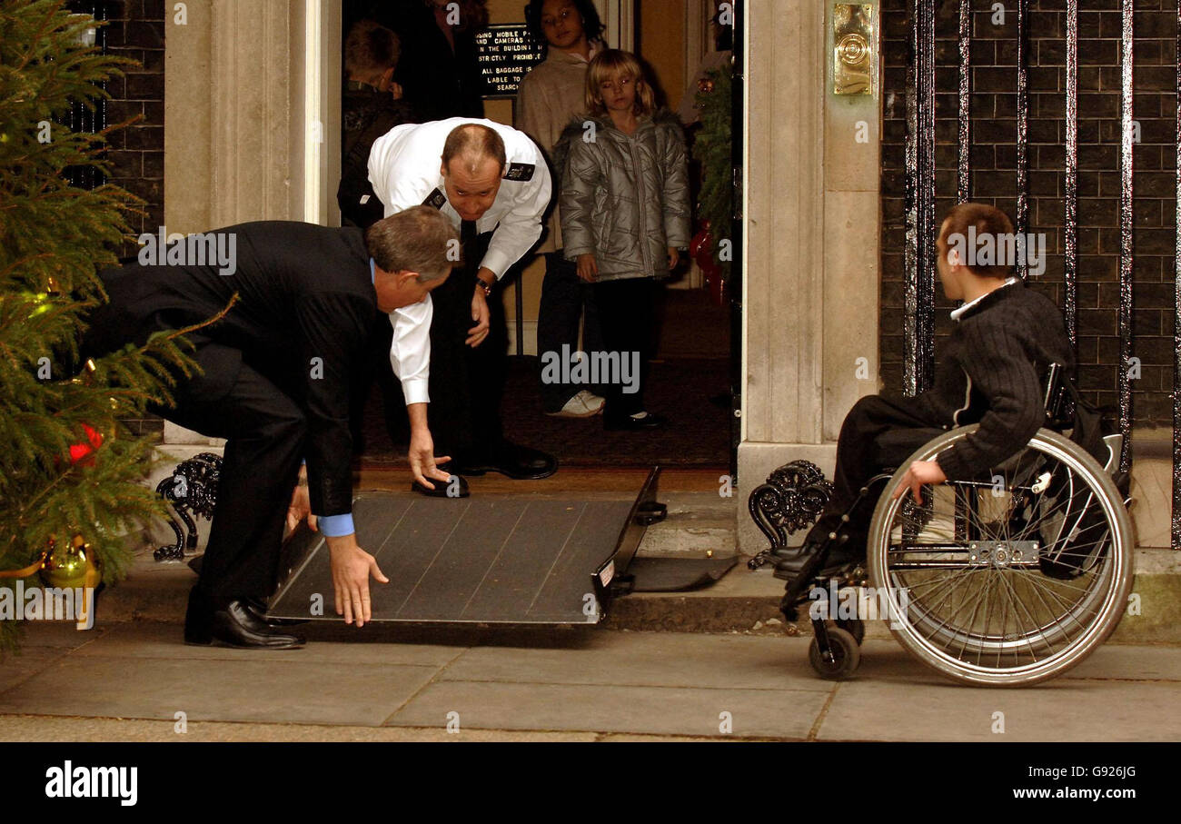 Britain's Prime Minister Tony Blair helps position a wheelchair ramp ...