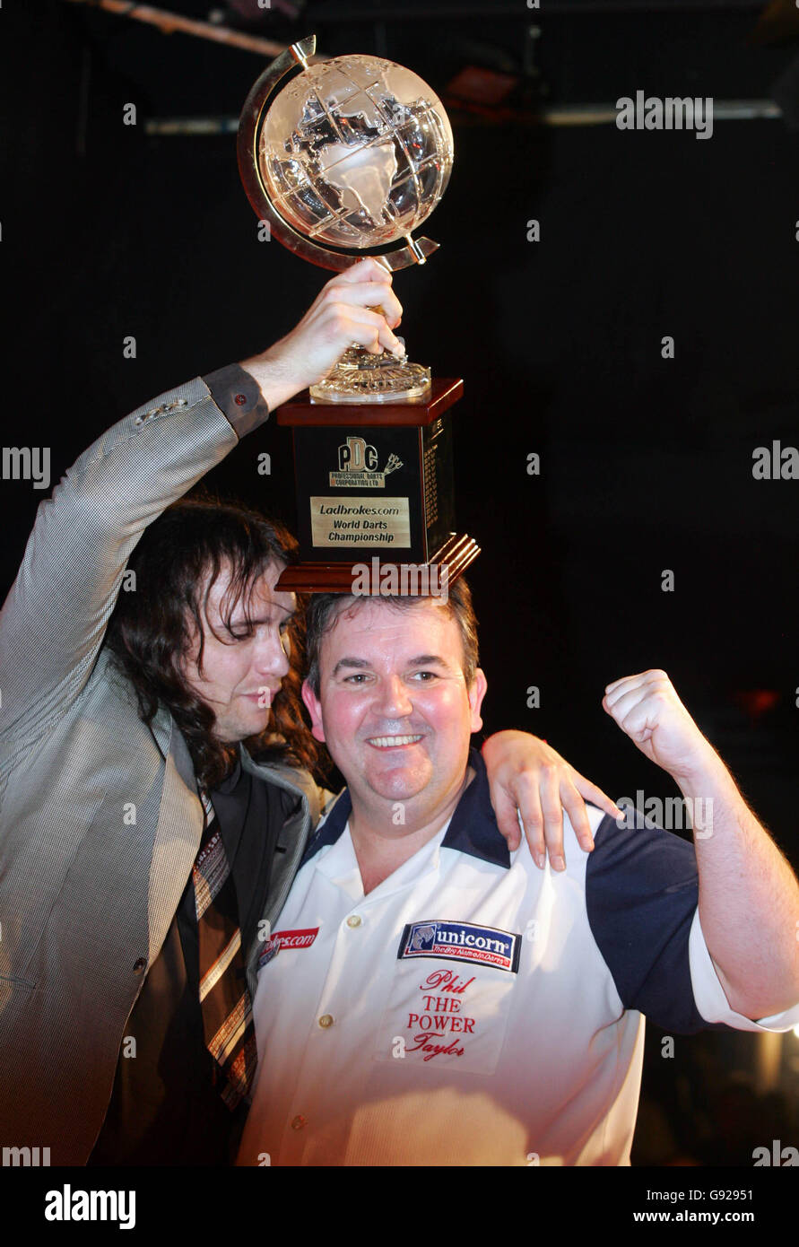 Phil Taylor and lead singer of the Darkness Justin Hawkins celebrate ...