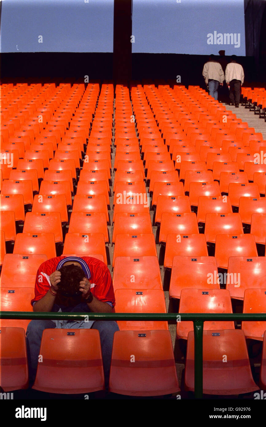 A Chile fan is the last to leave the stadium after watching his side ...