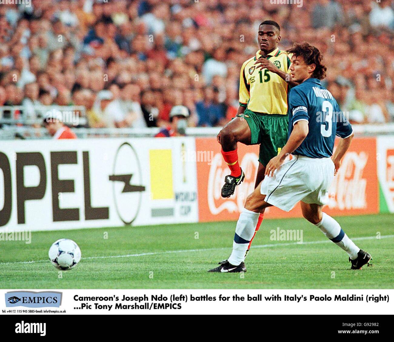Cameroon's Joseph Ndo (left) knocks the ball past Italy's Paolo Maldini ...