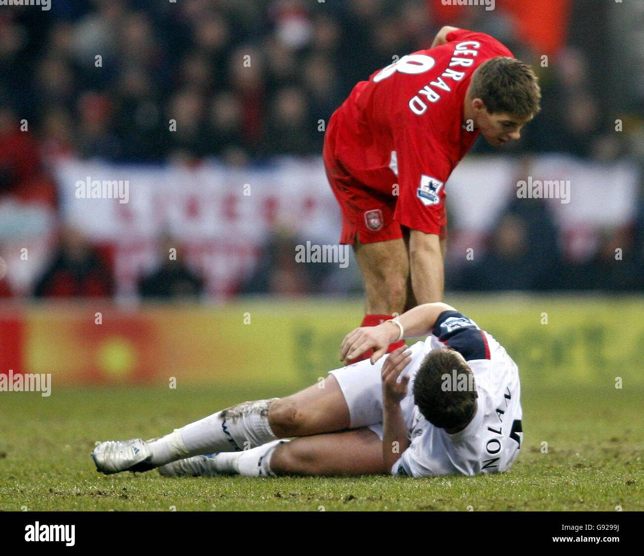 Bolton Wanderers' Kevin Nolan looks up at Liverpool's Steven Gerrard ...