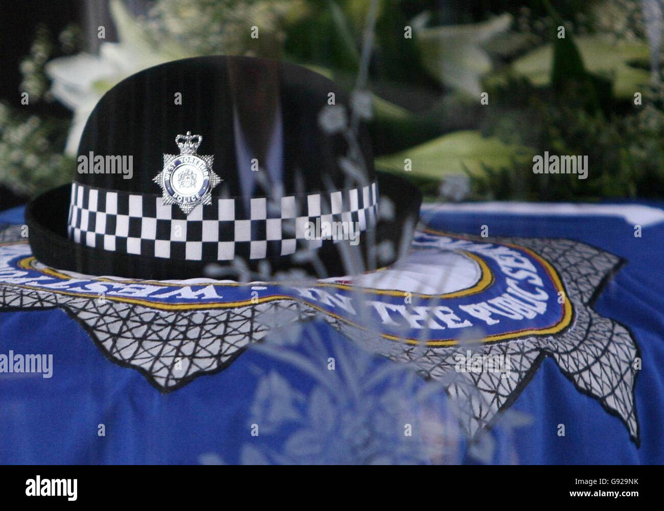 A police hat sits on top of the coffin of murdered police officer ...