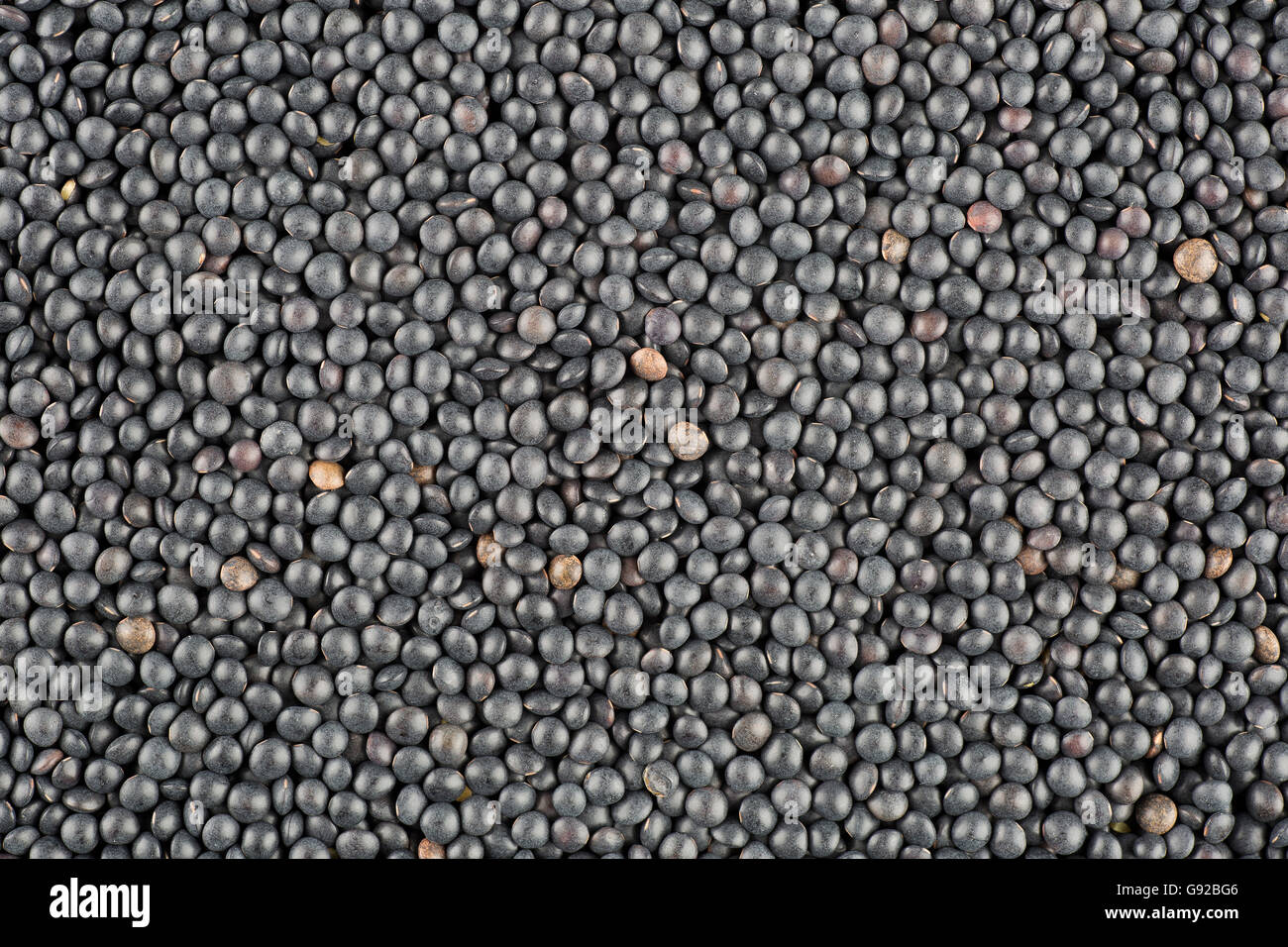 Black lentil food background texture Stock Photo - Alamy