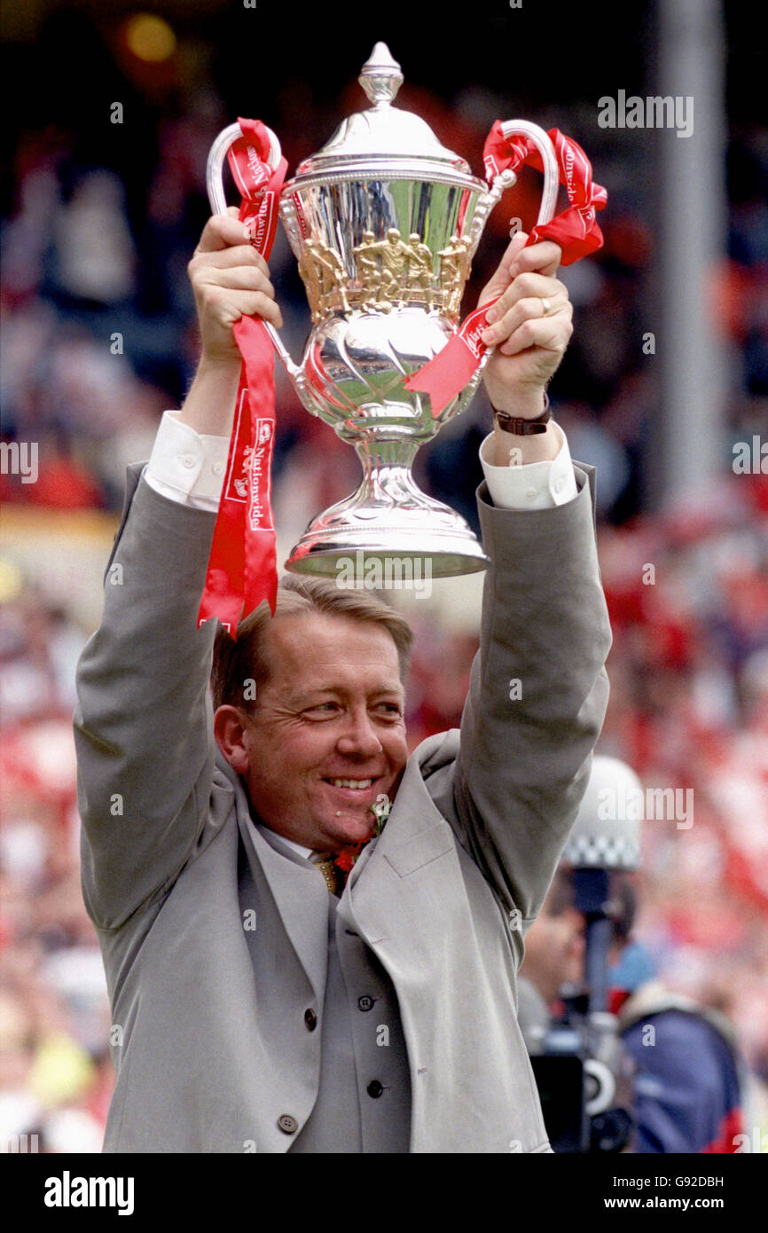Charlton athletic manager alan curbishley celebrates with the trophy hi ...