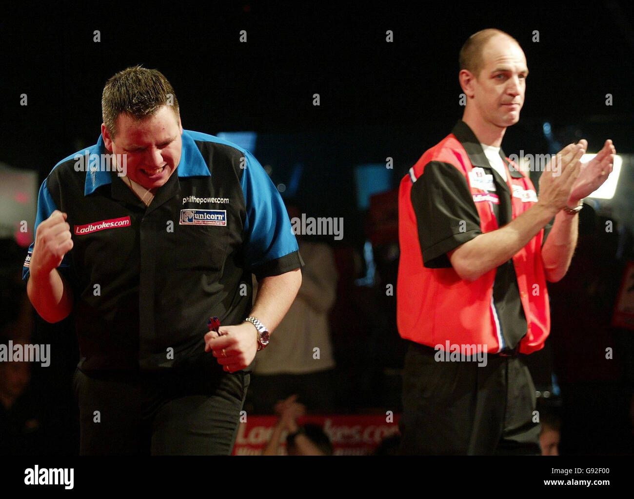 Adrian Lewis celebrates victory against Roland Scholten (R) in the ...
